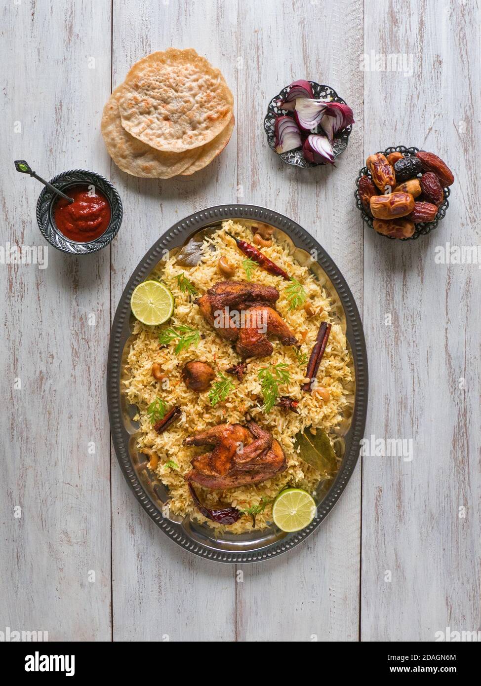 Chicken Mandi with dates on a wooden table. Arabic cuisine. Top view ...