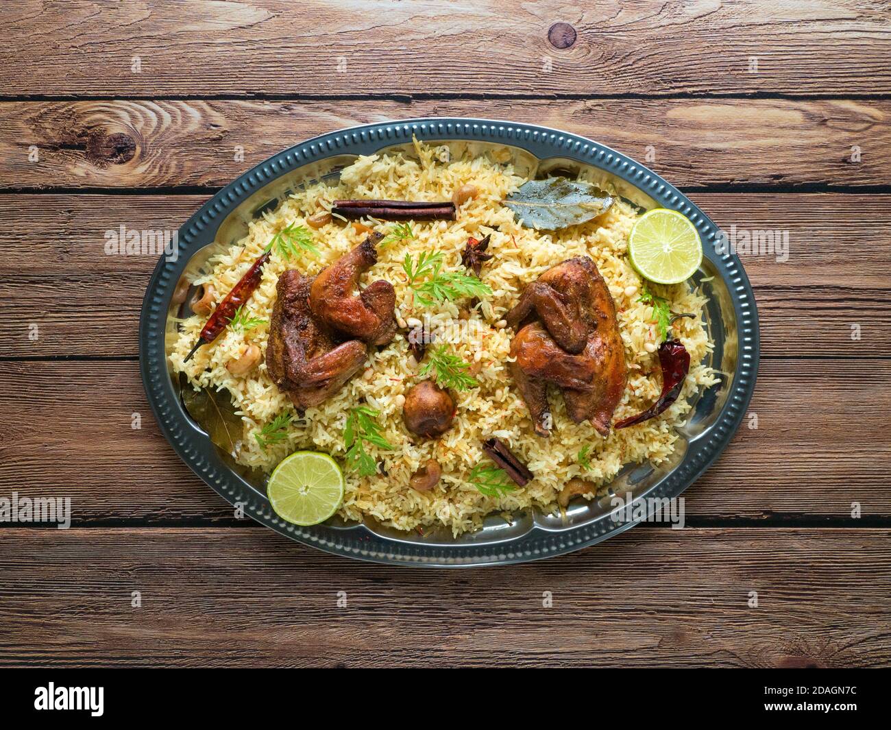 Chicken Mandi with dates on a wooden table. Arabic cuisine. Top view ...