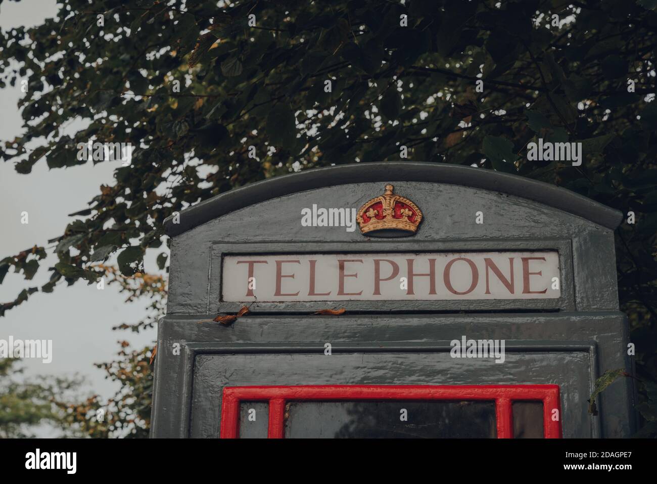 Frome, UK - October 7, 2020: Low angle view of red and grey phone box ...
