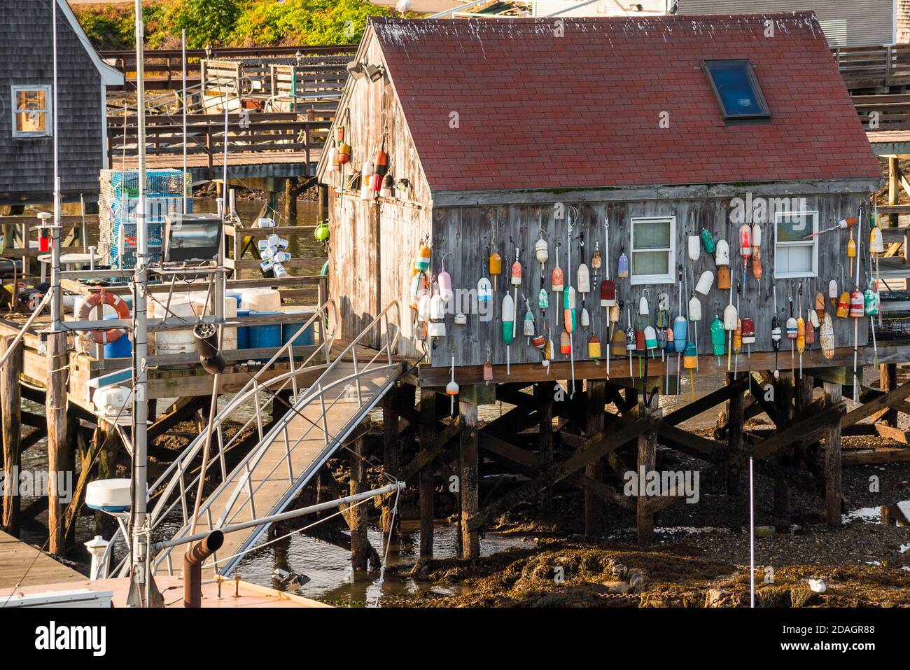 Traditional wooden fishing hut with colourful buoys hanging from the ...