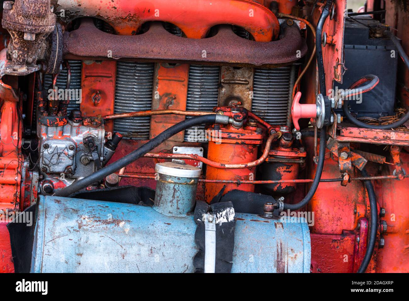 Old silver painted diesel tank on red vintage russian tractor engine ...