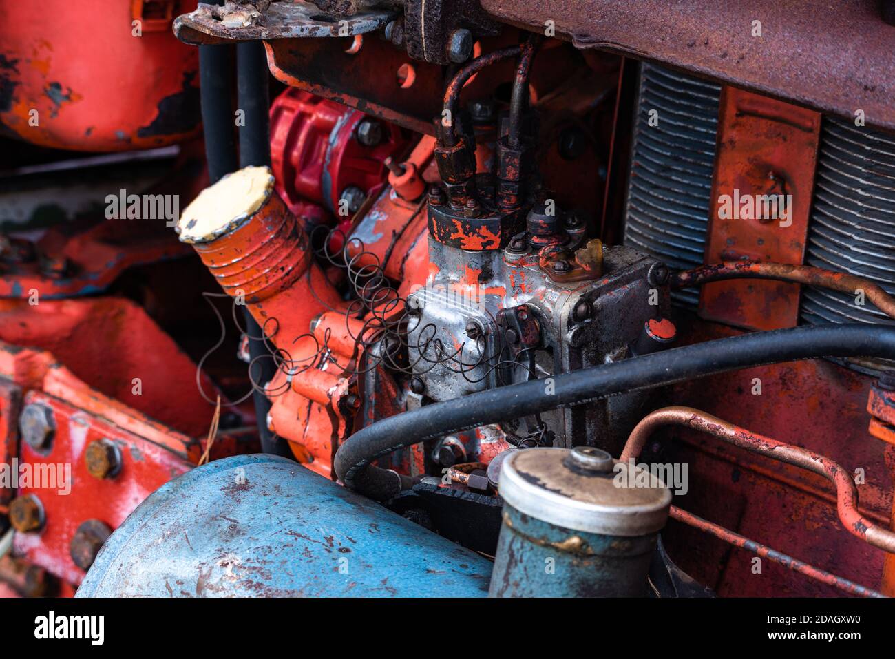 Closeup side view of old tractor engine red rusty vintage abstract ...