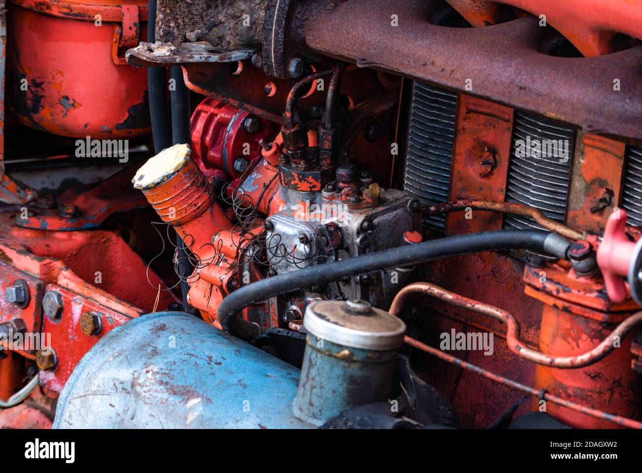 Closeup side view of old tractor engine red rusty vintage abstract ...