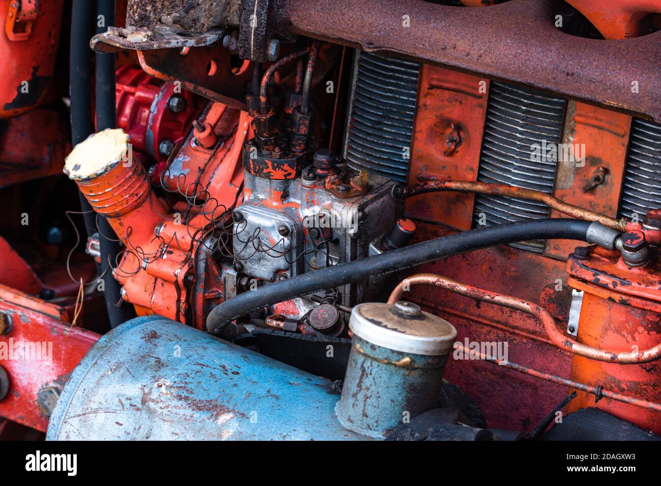 Closeup side view of old tractor engine red rusty vintage abstract ...