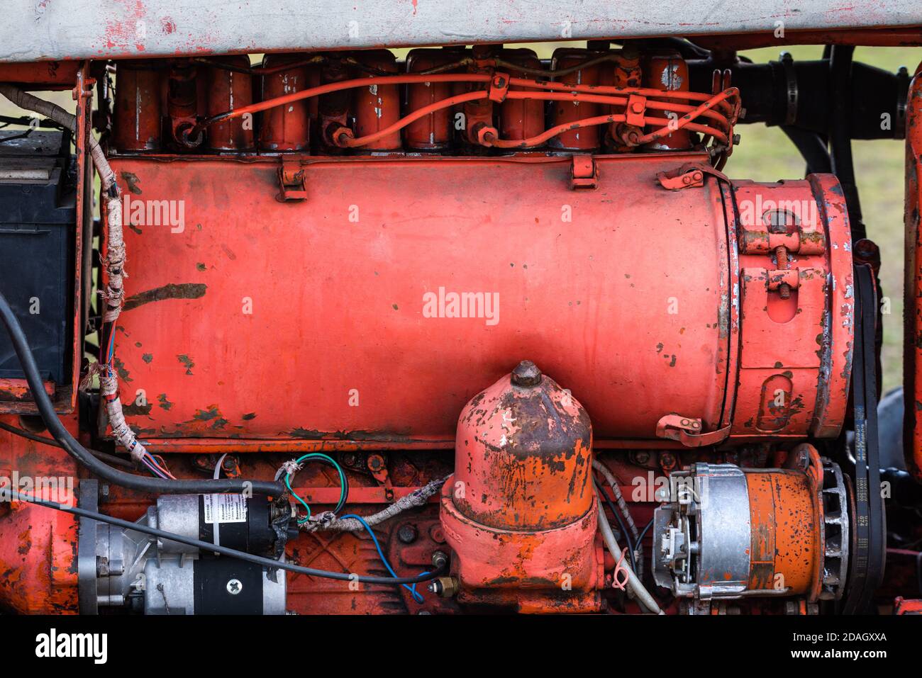 Closeup of four cylinder diesel tractor engine with visible belt rusty ...