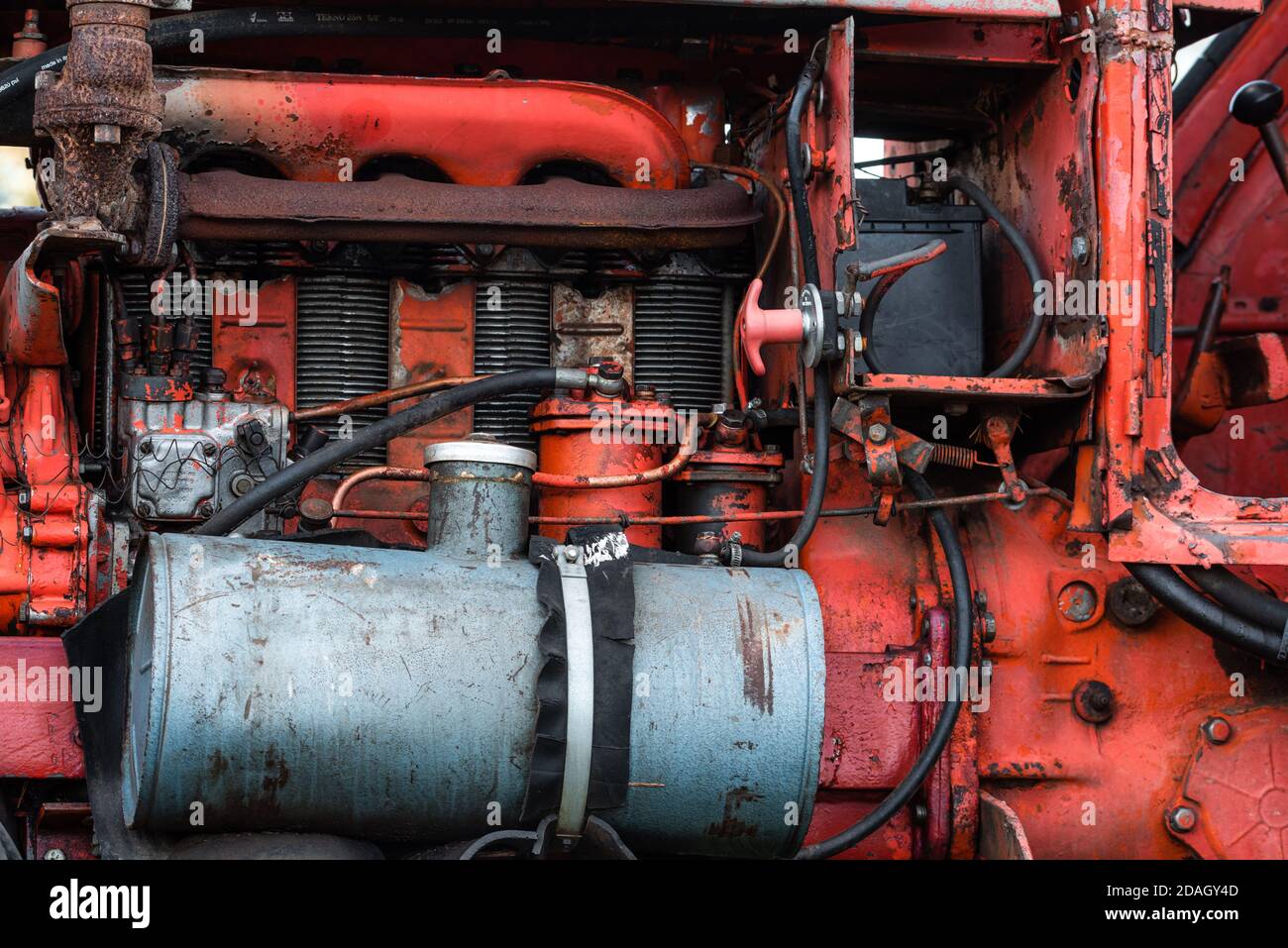 Old silver painted diesel tank on red vintage russian tractor engine ...
