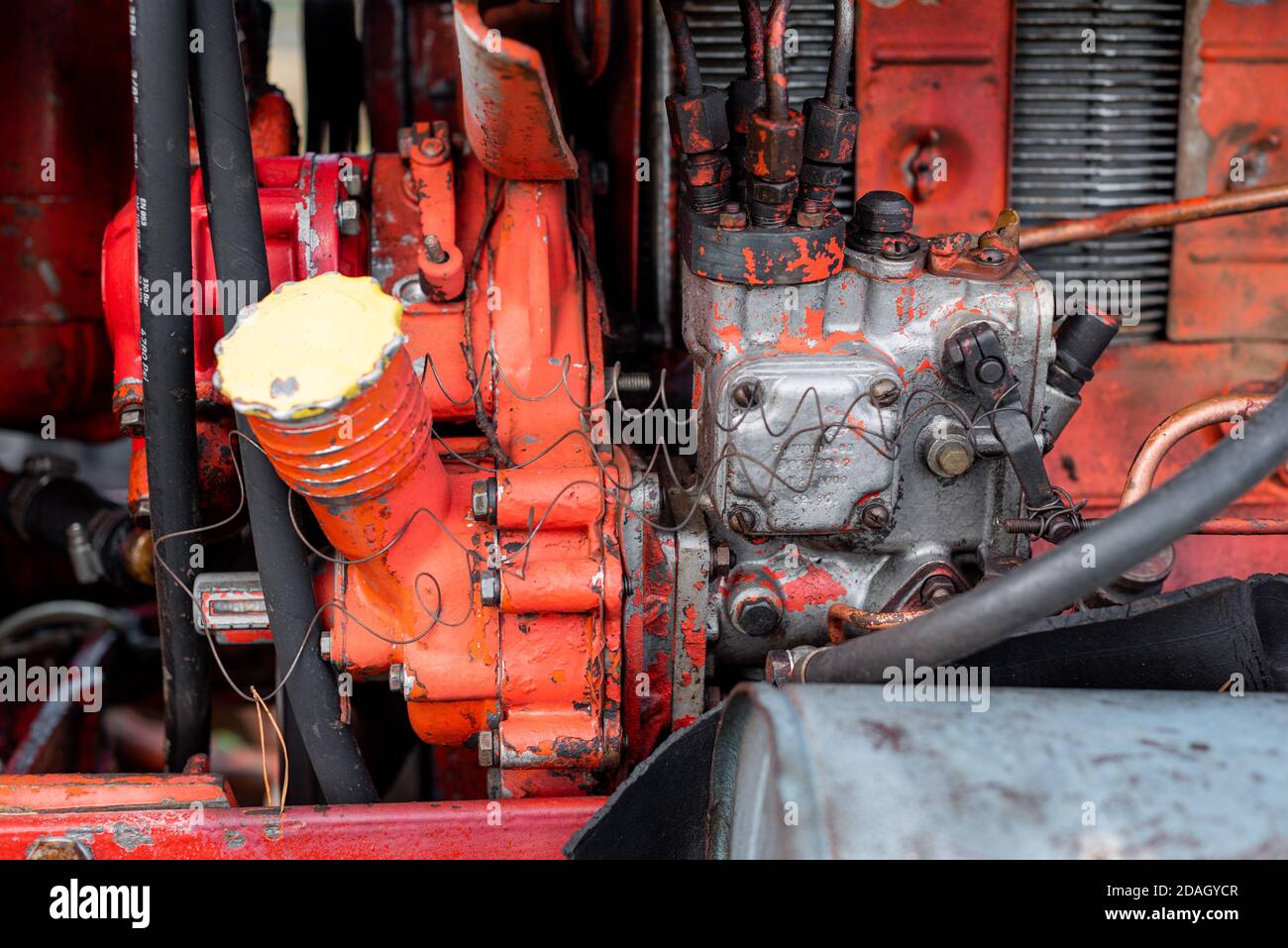 Closeup side view of old tractor engine red rusty vintage abstract ...