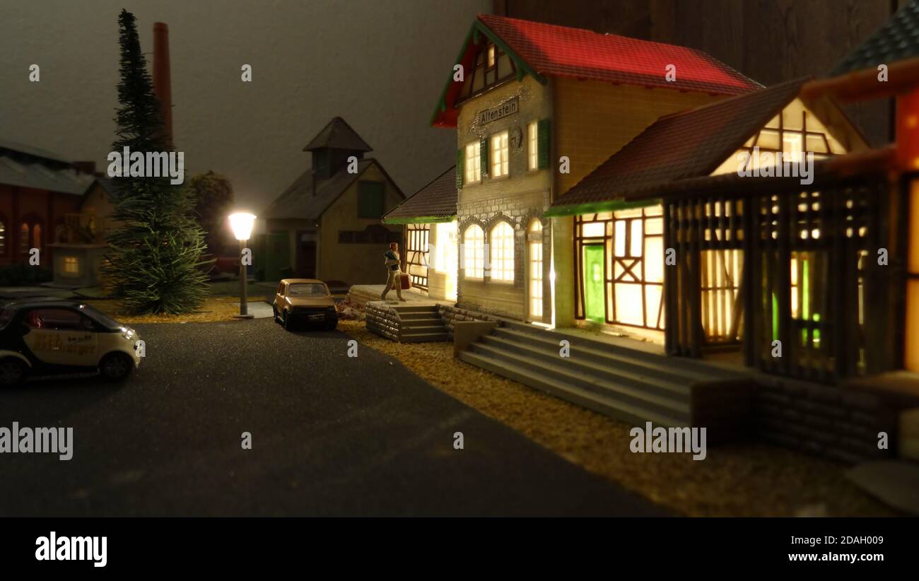 illuminated miniature train station with car in front model railway ...