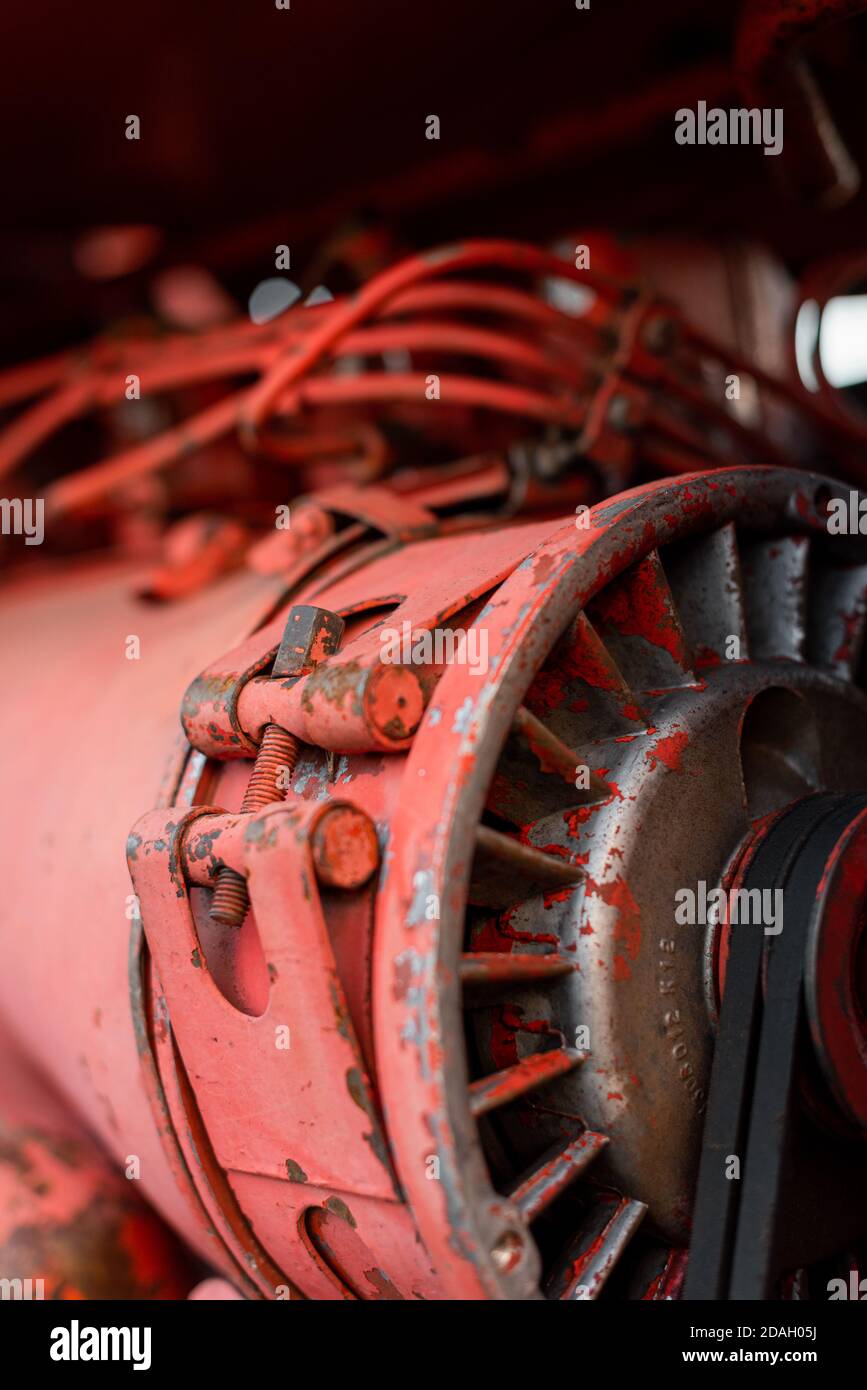 Closeup of red tractor fuel injectors four cylinder diesel engine ...