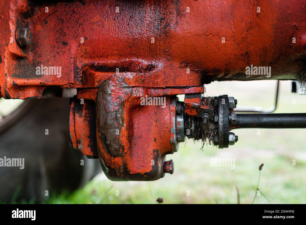 Closeup of old red rusty tractor transmission differential on russian ...