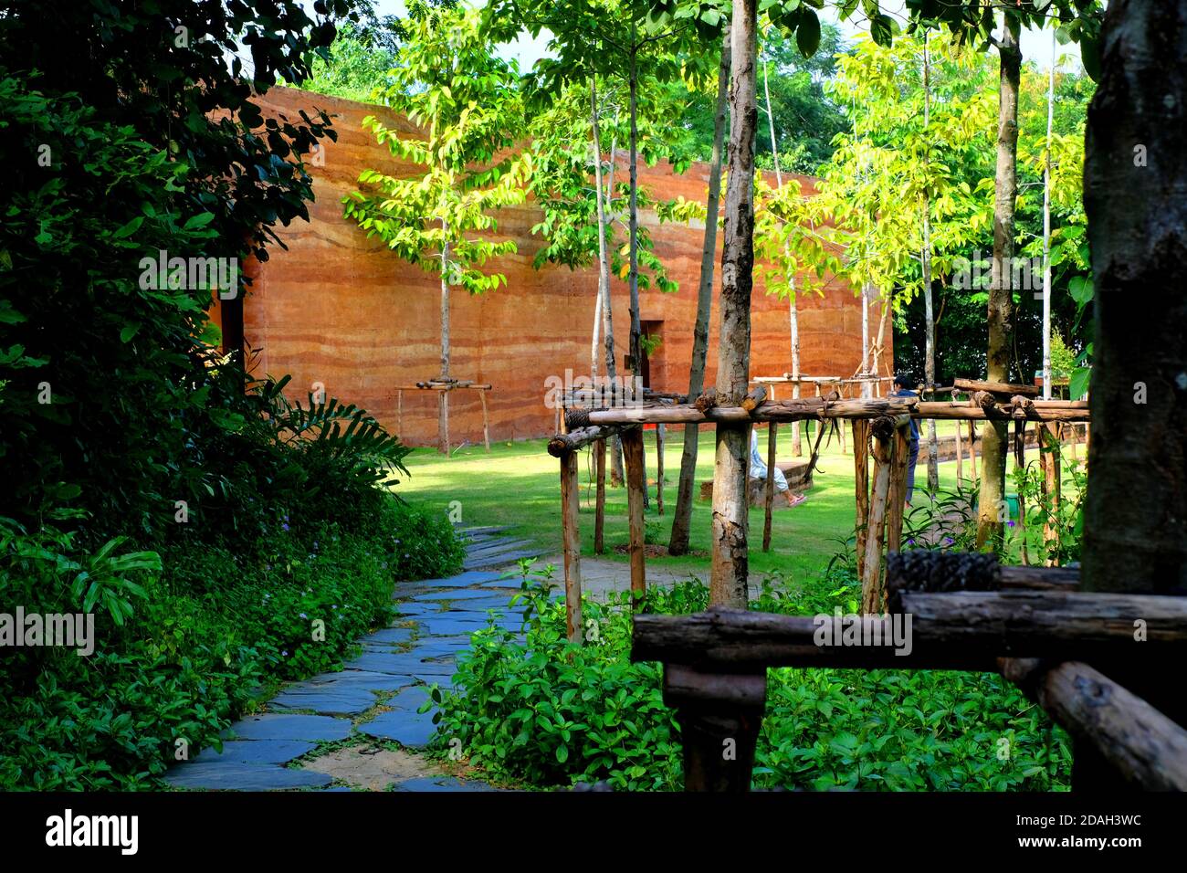 Path walk amid trees leads to grass terrace Stock Photo - Alamy