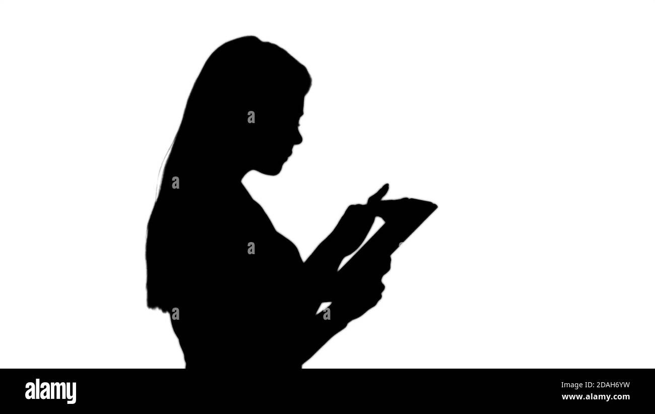 Silhouette Girl holding digital tablet searching for something Stock ...