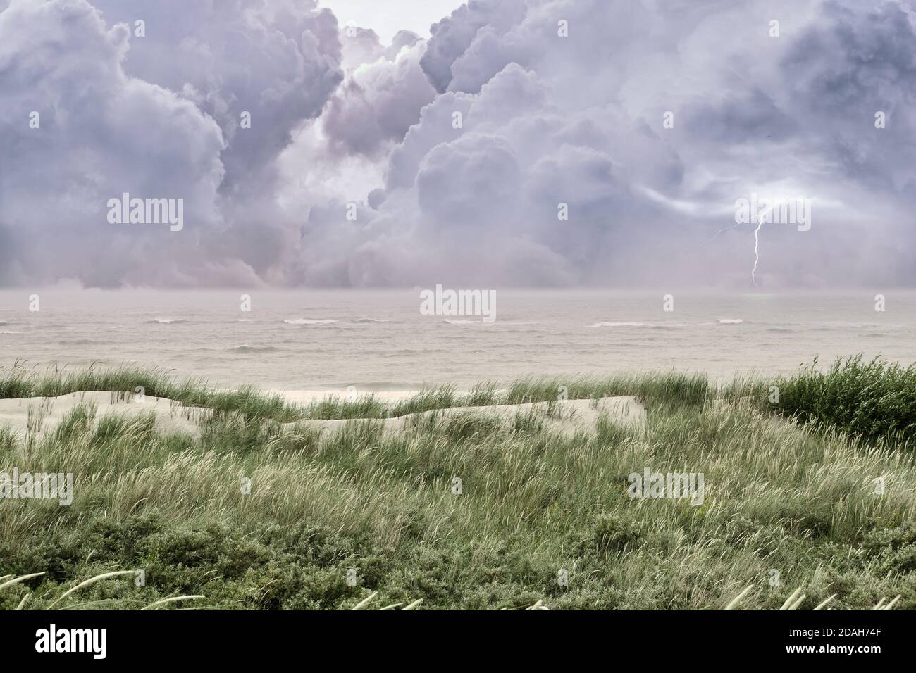 Dramatic overcast sky on beach with lightening bolt in horizon over ...