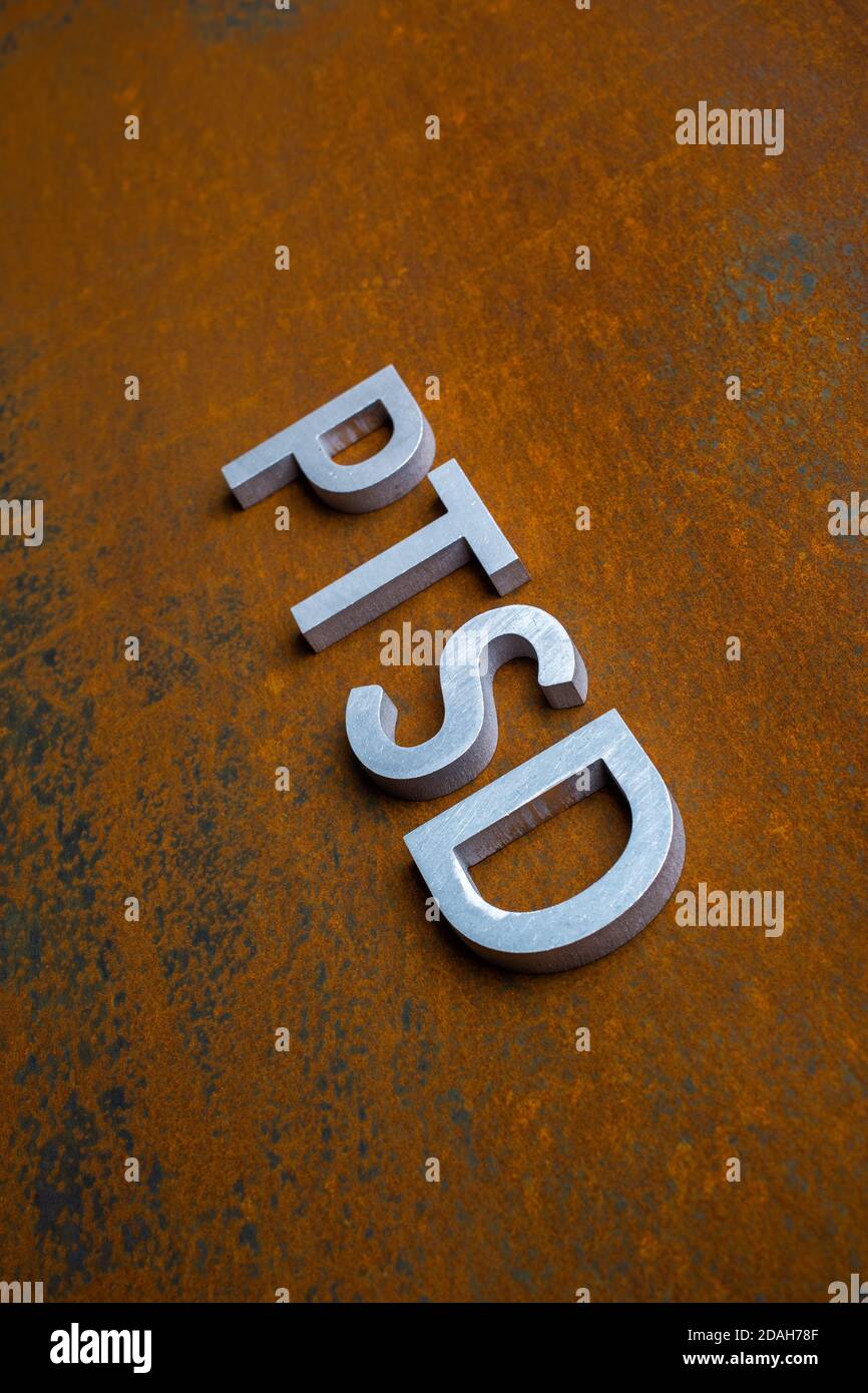 the word PTSD - post traumatic stress disorder - laid with silver metal ...