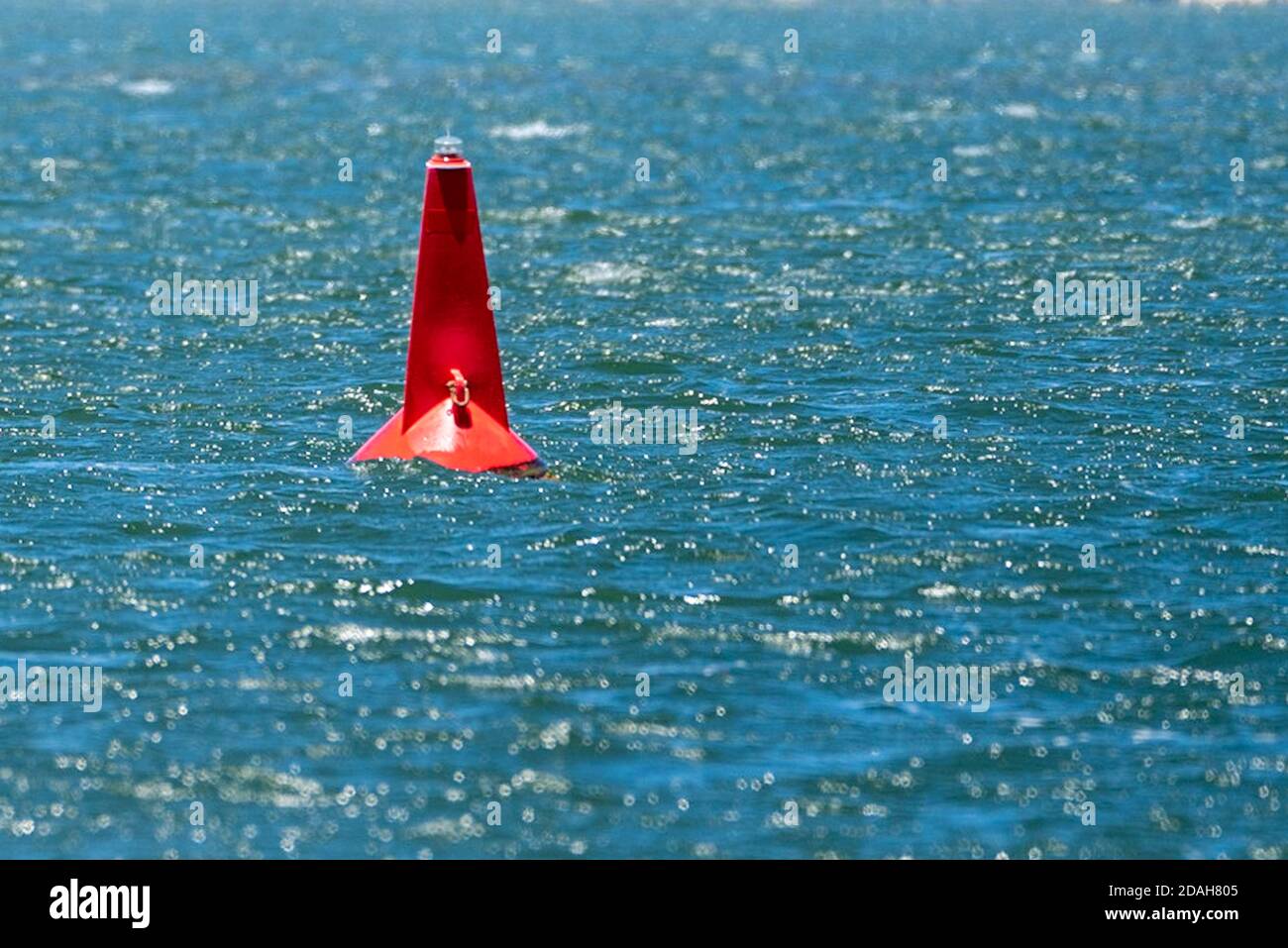 A red navigation beacon floating on the water Stock Photo - Alamy
