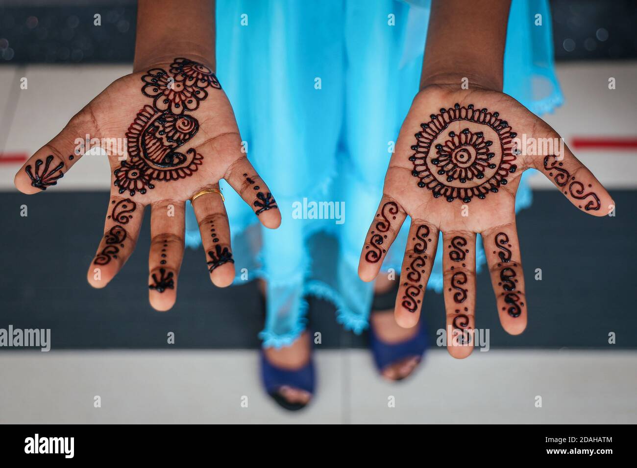 An Indian girl displays her hands decorated with henna paste ahead of ...