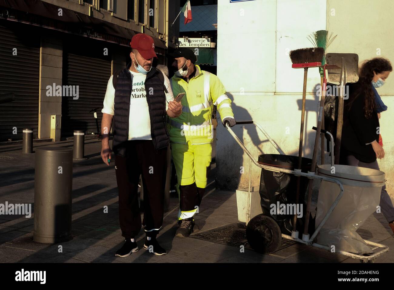 A municipal street sweeper works on the street wearing a coronavirus ...