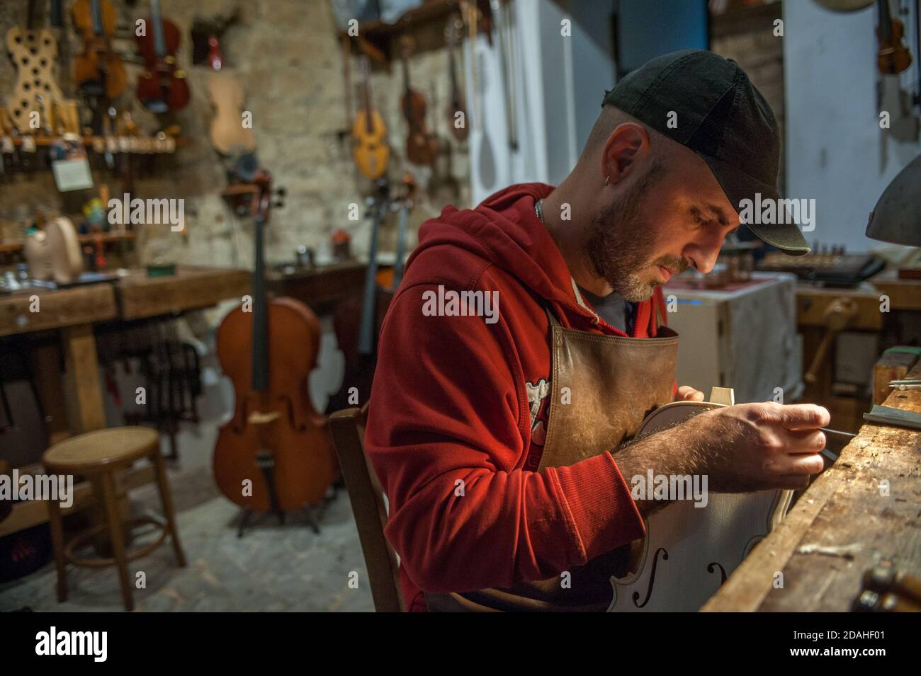 Neapolitan violin maker Alessandro Zanesco working in his atelier Stock ...
