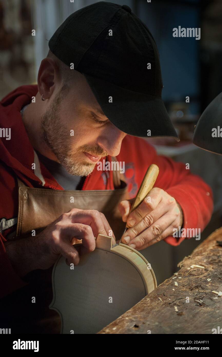 Neapolitan violin maker Alessandro Zanesco working in his atelier Stock ...
