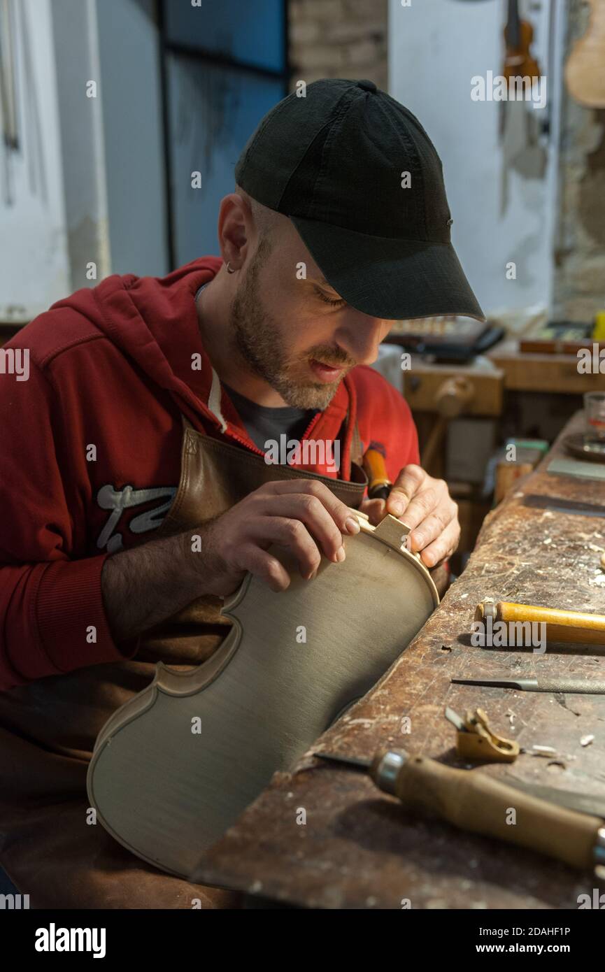 Neapolitan violin maker Alessandro Zanesco working in his atelier Stock ...