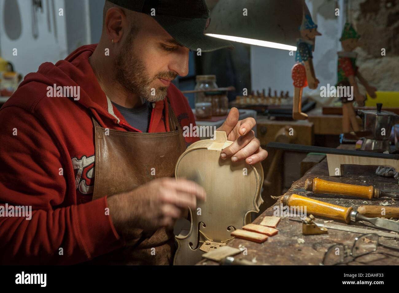 Neapolitan violin maker Alessandro Zanesco working in his atelier Stock ...