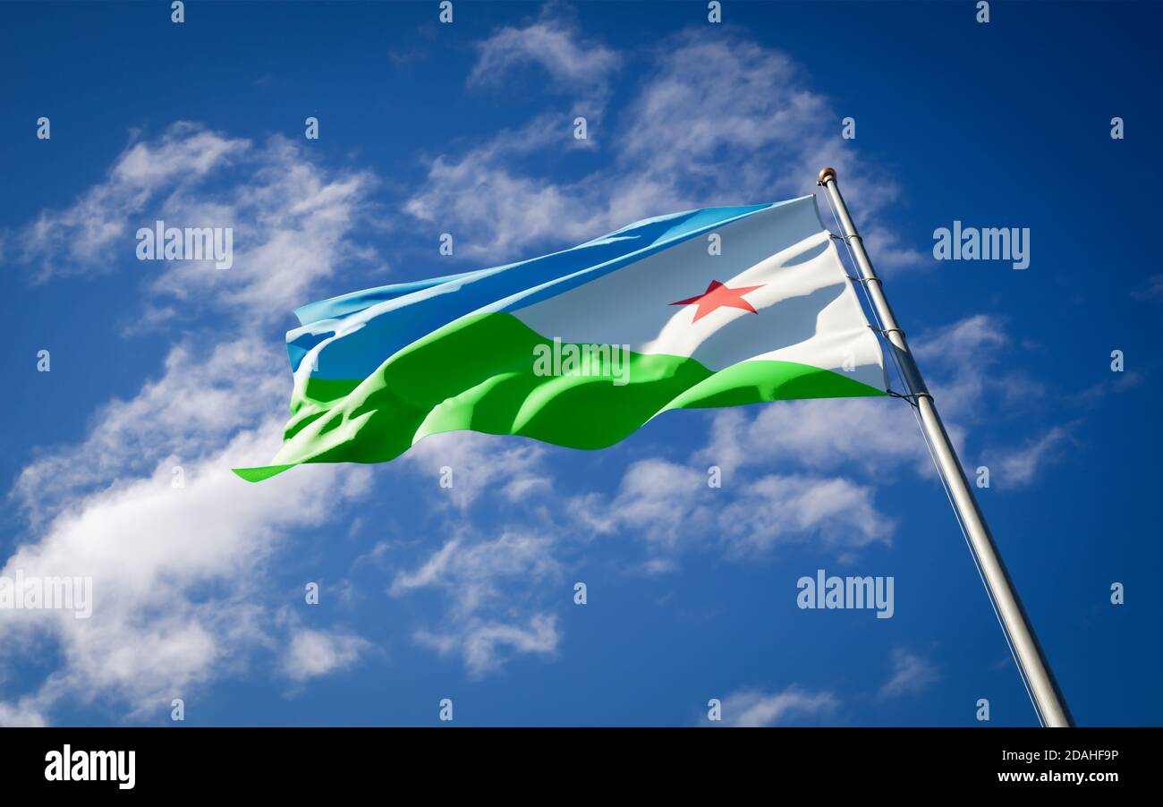 Beautiful national state flag of Djibouti fluttering at sky background ...