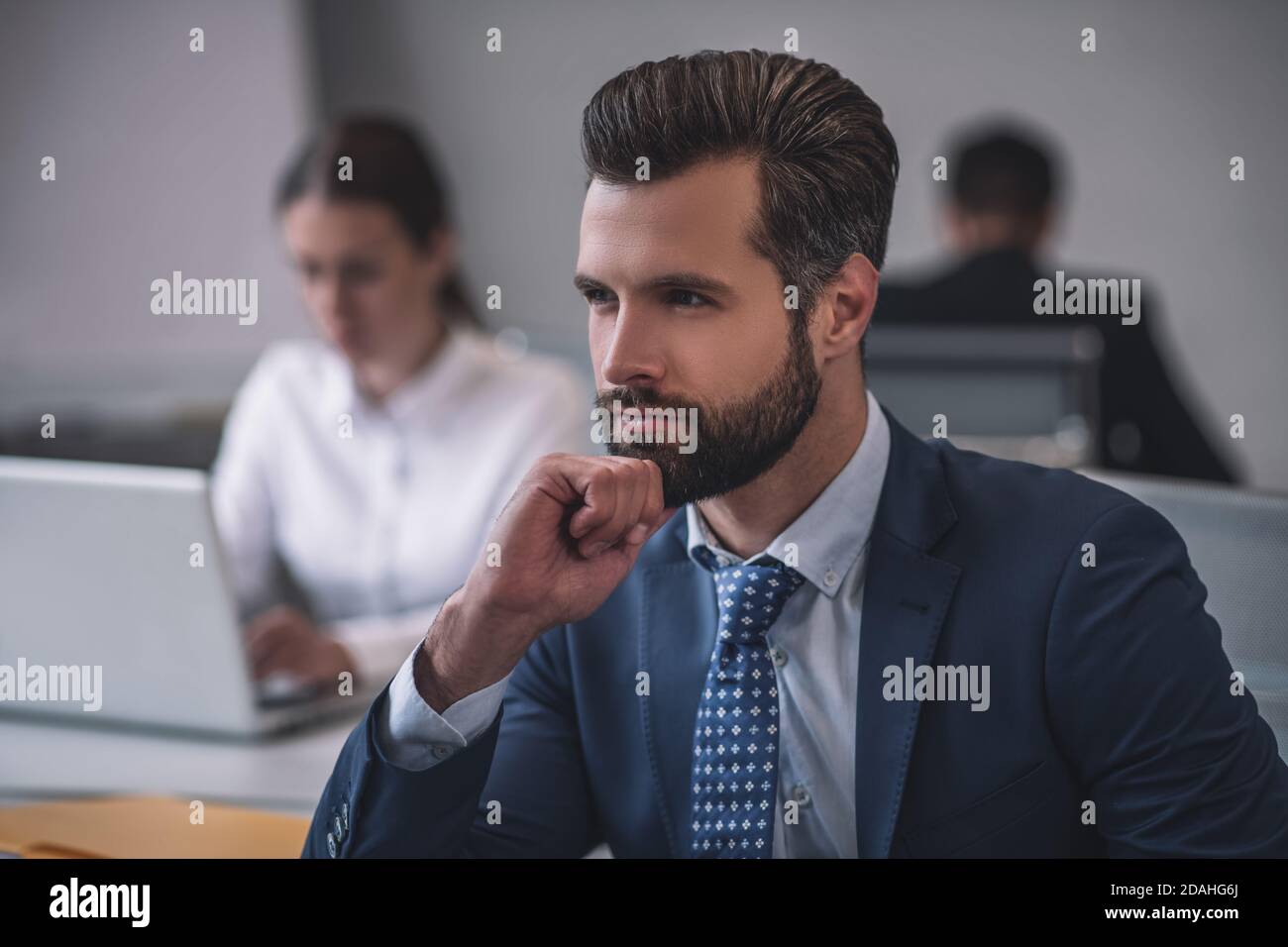 Man in suit sitting back hi-res stock photography and images - Alamy