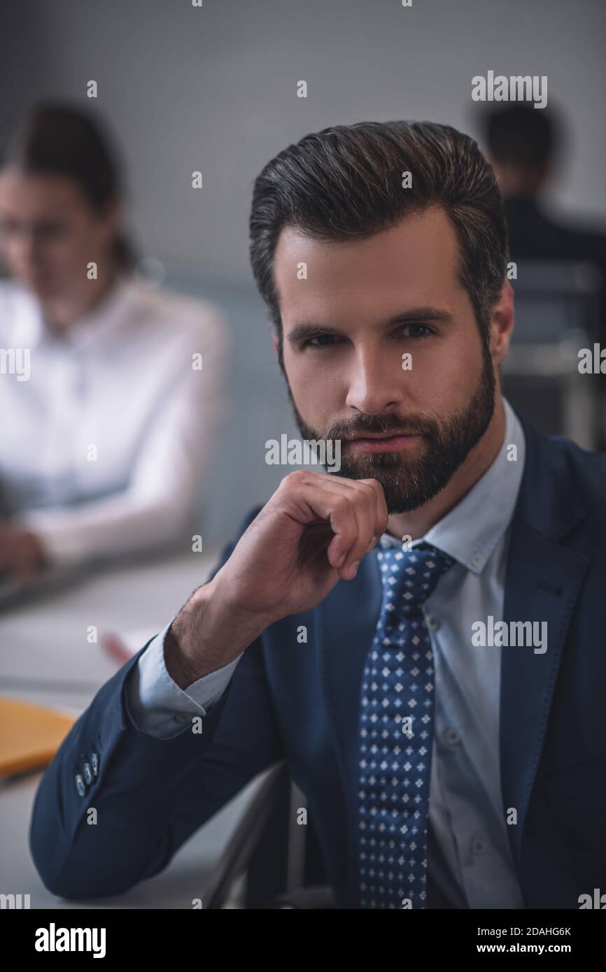 Man in suit looking forward confidently in office Stock Photo - Alamy