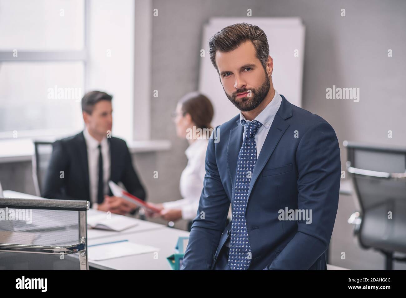 Attractive man in business suit and tie in office Stock Photo - Alamy