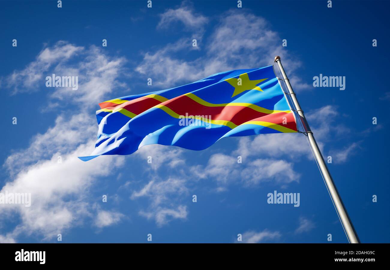 Beautiful national state flag of Congo fluttering at sky background ...