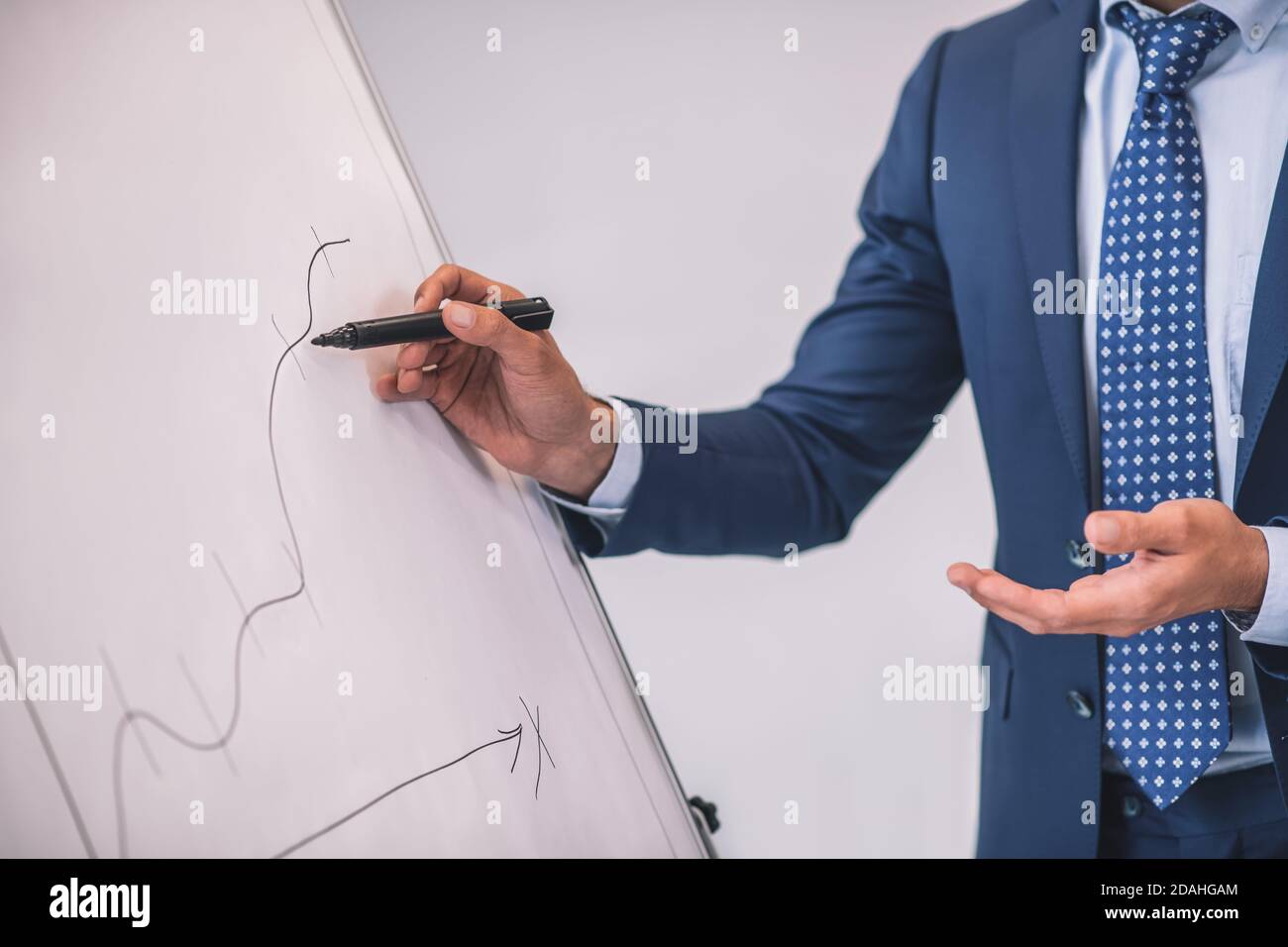 Male hands showing graph drawn by marker Stock Photo - Alamy