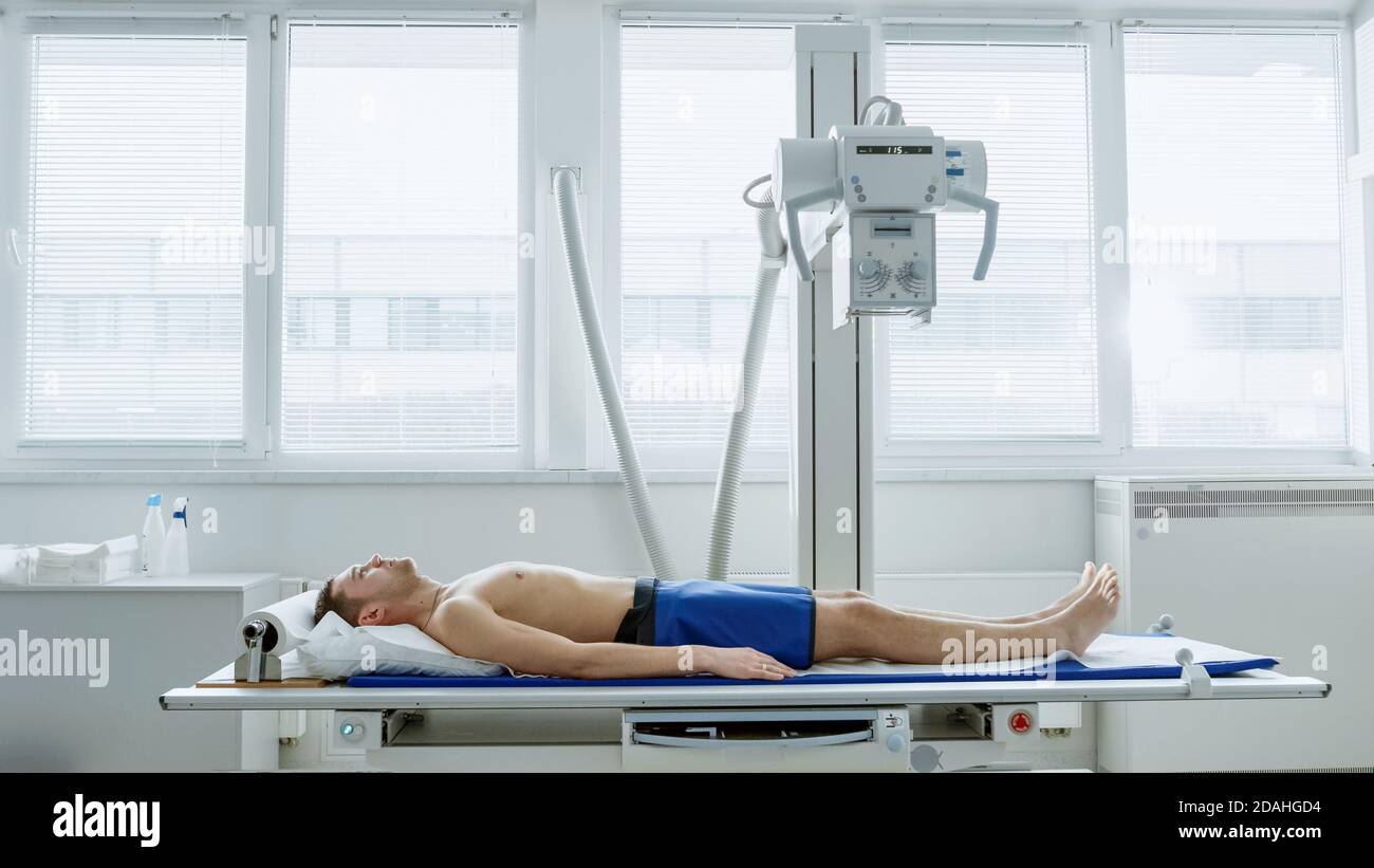 In the Hospital, Man Lying on a Bed Waiting for X-Ray Machine to Scan ...