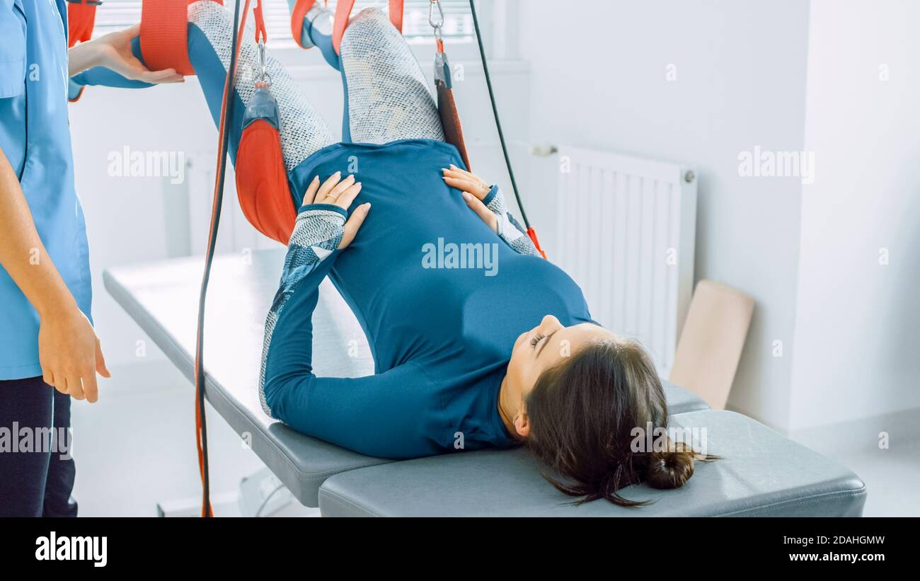 Physiotherapist Assists Female Patient with Trauma, Undergoing ...