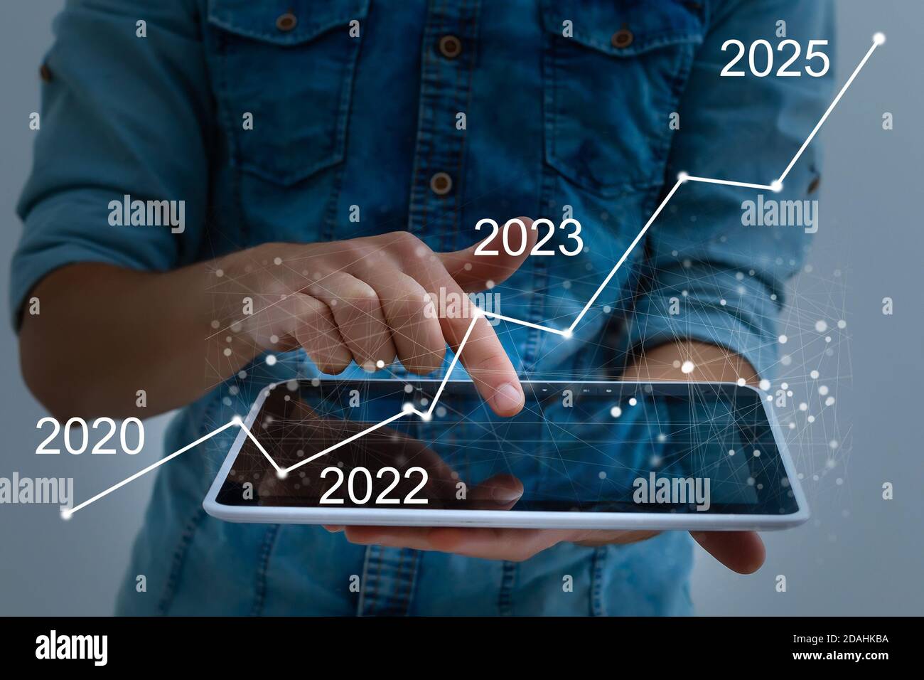 Man's hand pointing graph of success in 2023 year. Growing business ...