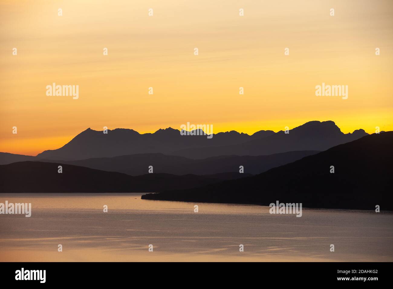 A beautiful sunset behind the Skye ridge seen from Arnisdale Stock ...