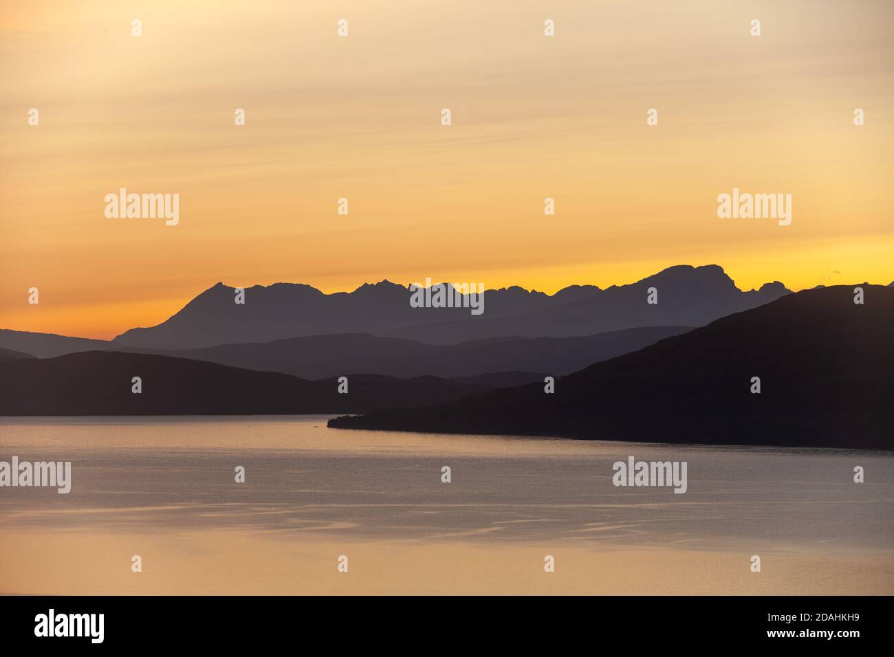 A beautiful sunset behind the Skye ridge seen from Arnisdale Stock ...