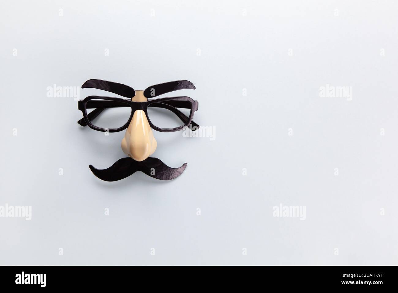 Carnival mask with moustache, nose and glasses on grey background, copy ...