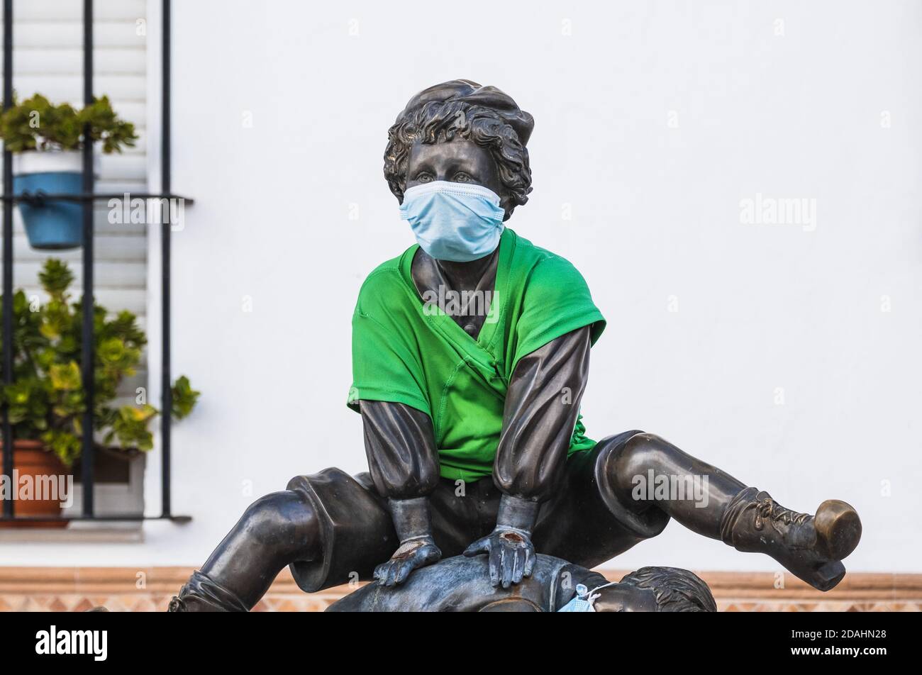 Bronze statues of two children playing in the street jumping on top of ...