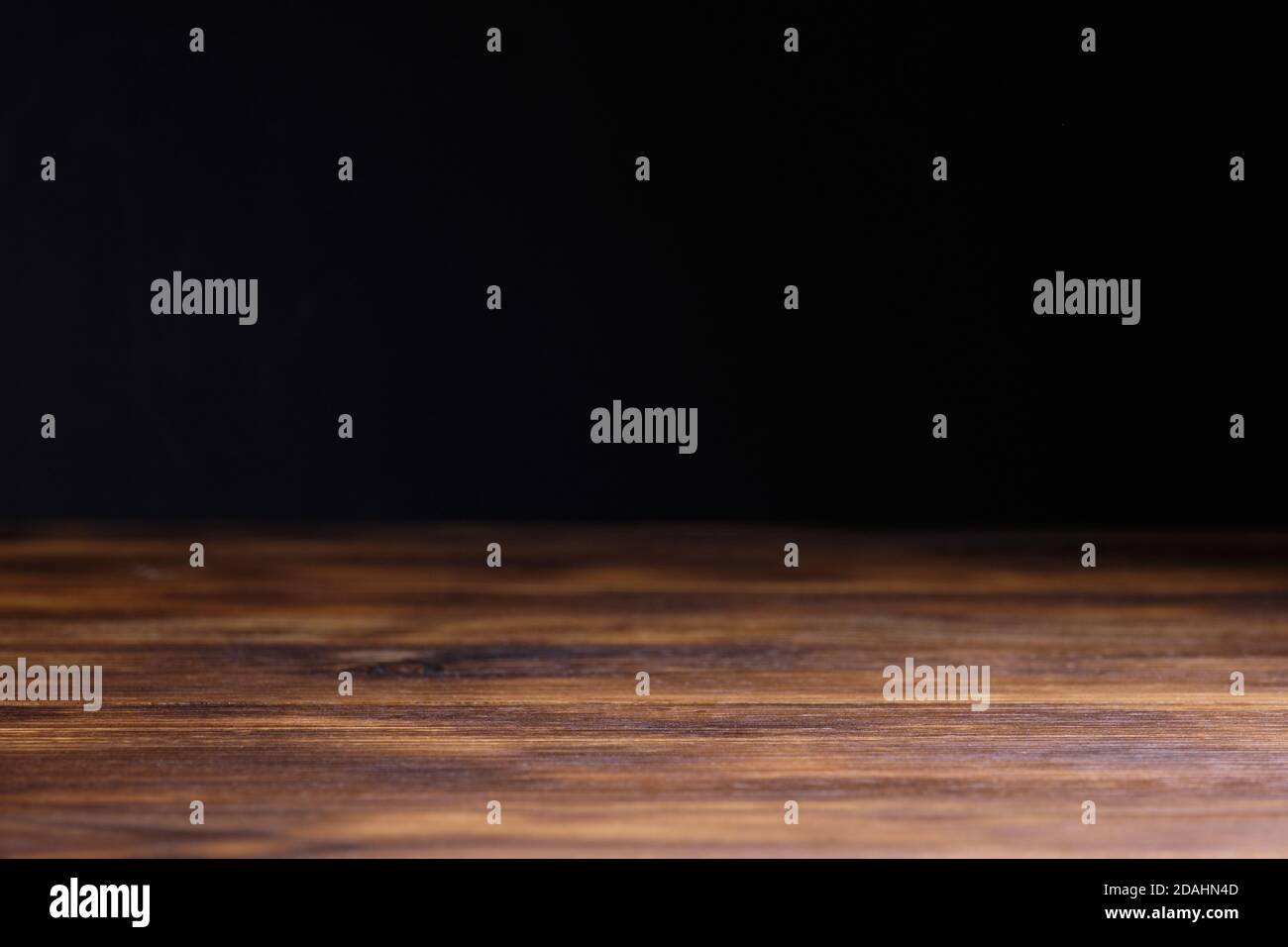Wooden burnt table on black background for advertising Stock Photo - Alamy