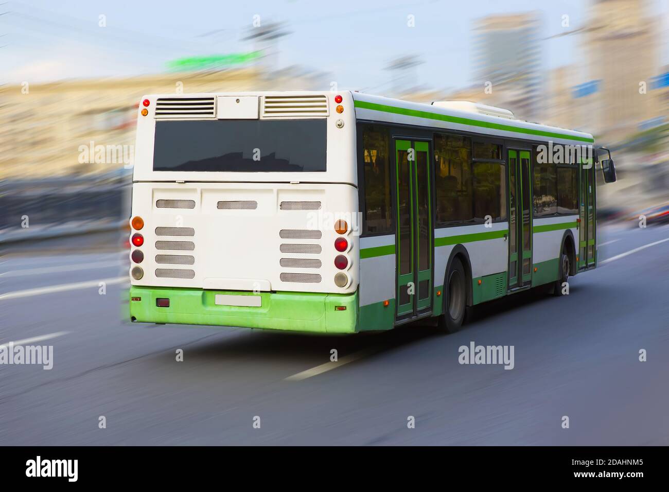 white city bus goes along street Stock Photo - Alamy
