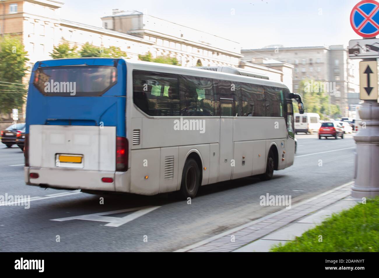 white city bus goes along street Stock Photo - Alamy