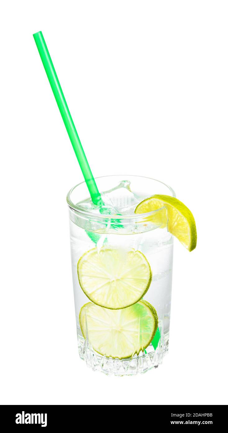 gin and tonic cocktail in glass with wedge and slices of lime, ice and ...