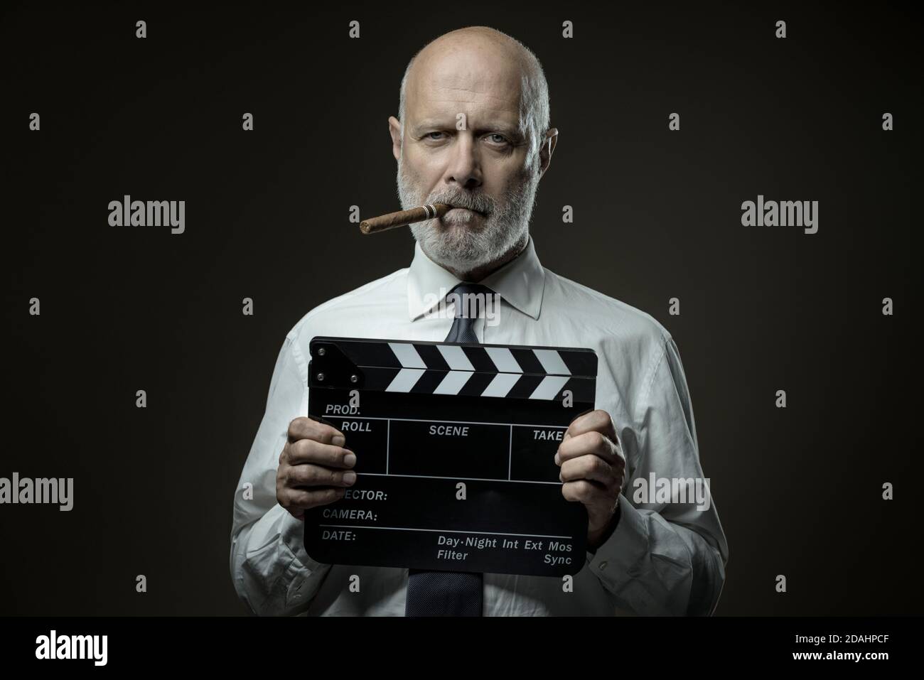 Middle-aged film director holding a clapperboard, cinematography and ...