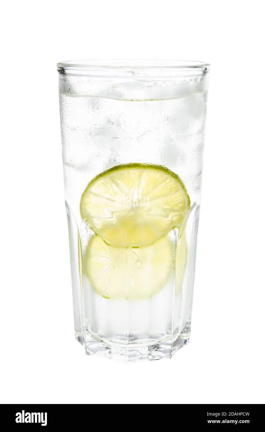 side view of gin and tonic cocktail in highball glass with two slices of lime and ice isolated ...