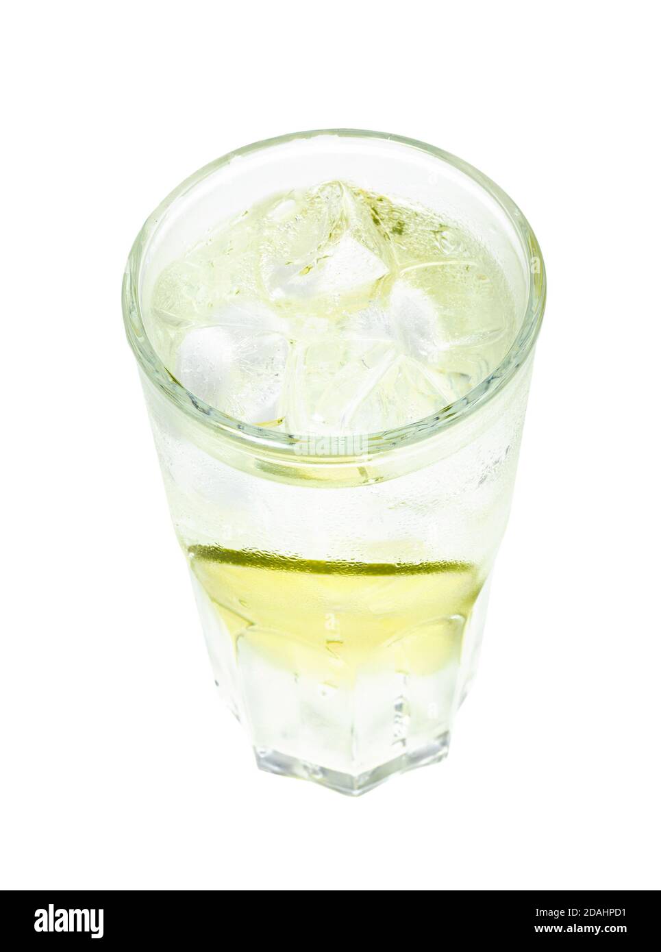 above view of gin and tonic cocktail in highball glass with slices of lime and cubes of ice ...