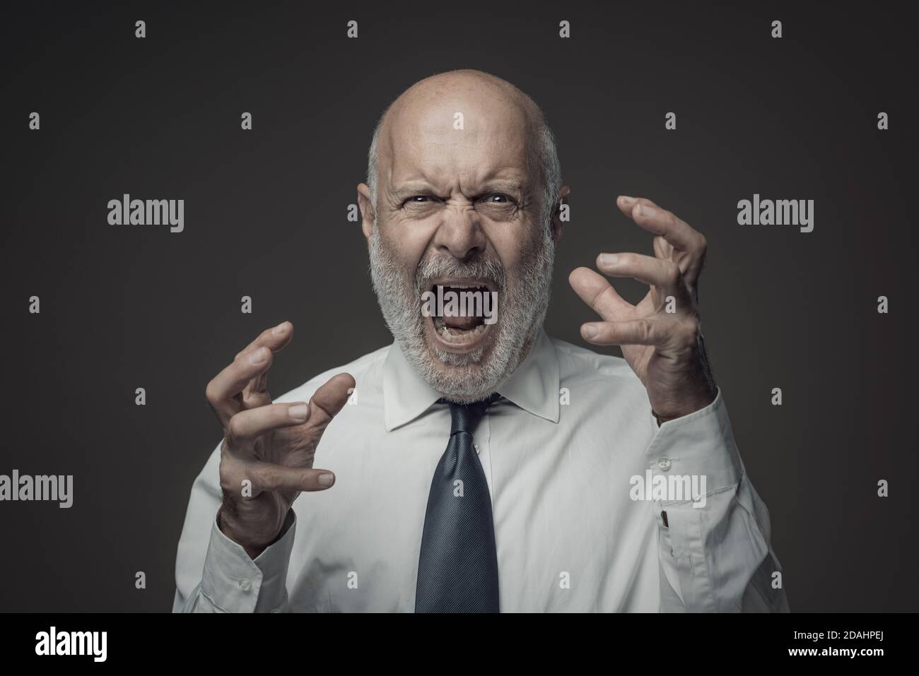 Angry aggressive corporate businessman shouting at camera, he is ...