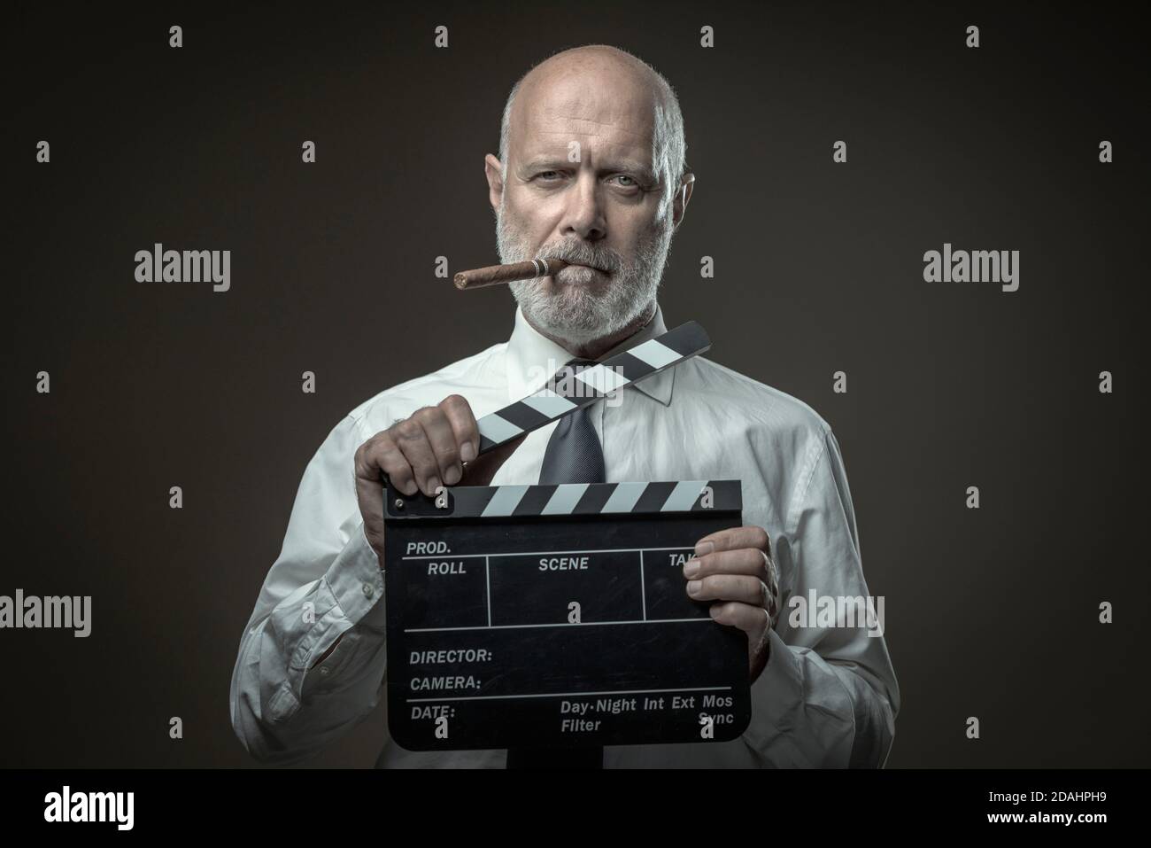 Middle-aged film director holding a clapperboard, cinematography and ...