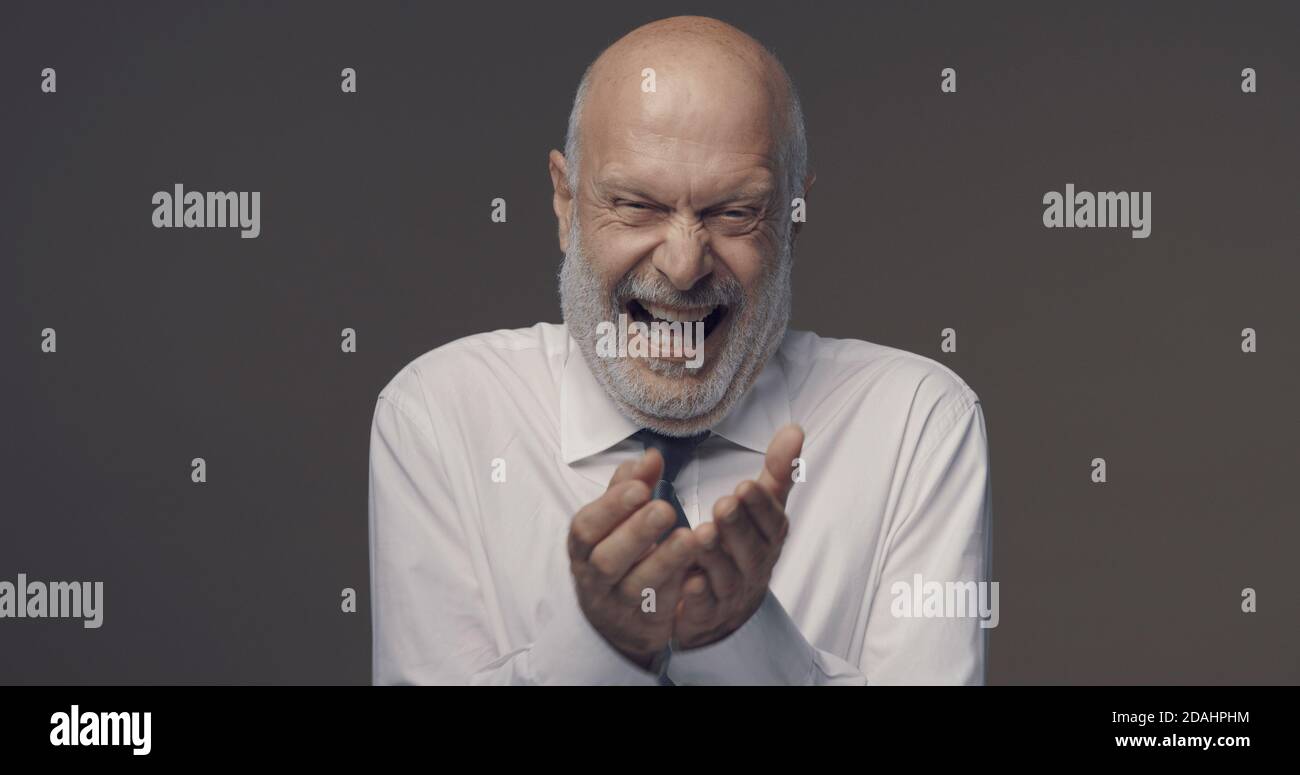 Cheerful middle-aged corporate businessman laughing out loud Stock ...