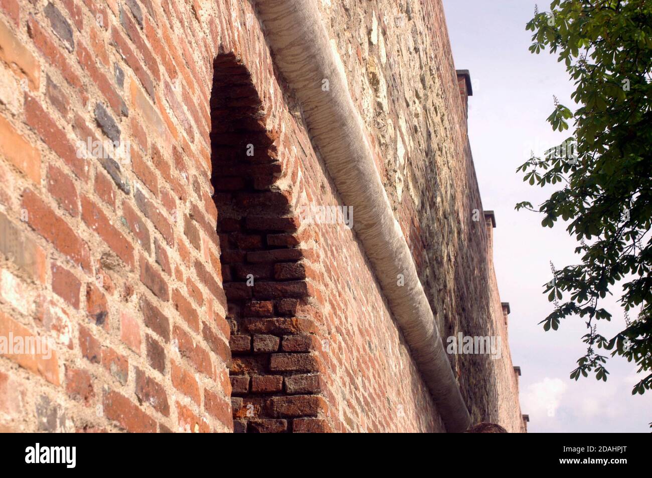 an unplastered red brick wall as part of a building Stock Photo - Alamy