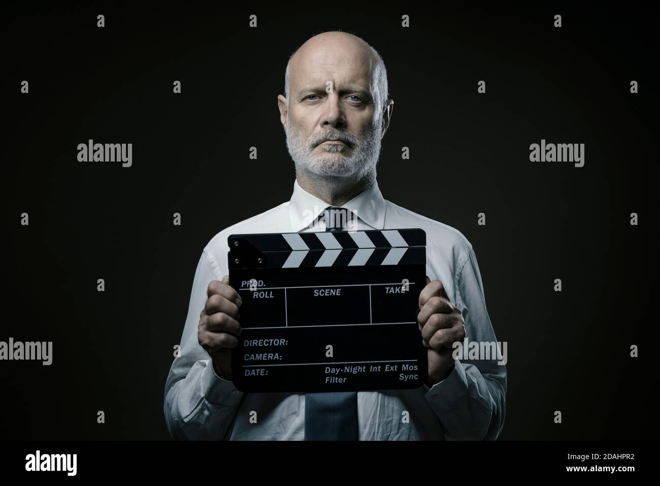 Middle-aged film director holding a clapperboard, cinematography and ...